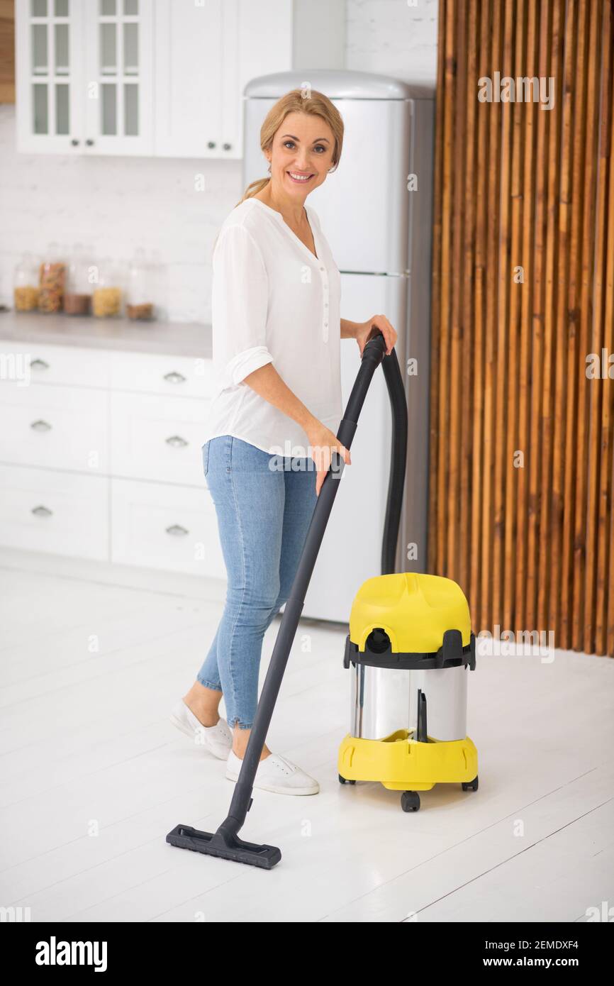 Blonde woman in cleaning vacuum hi-res stock photography and images - Alamy