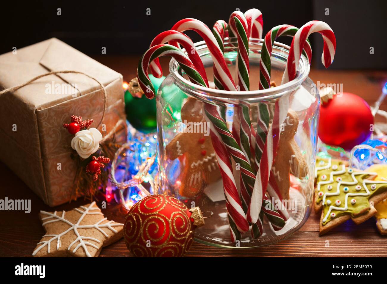 Christmas still life. homemade ginger biscuits, cane candy, on a wooden ...