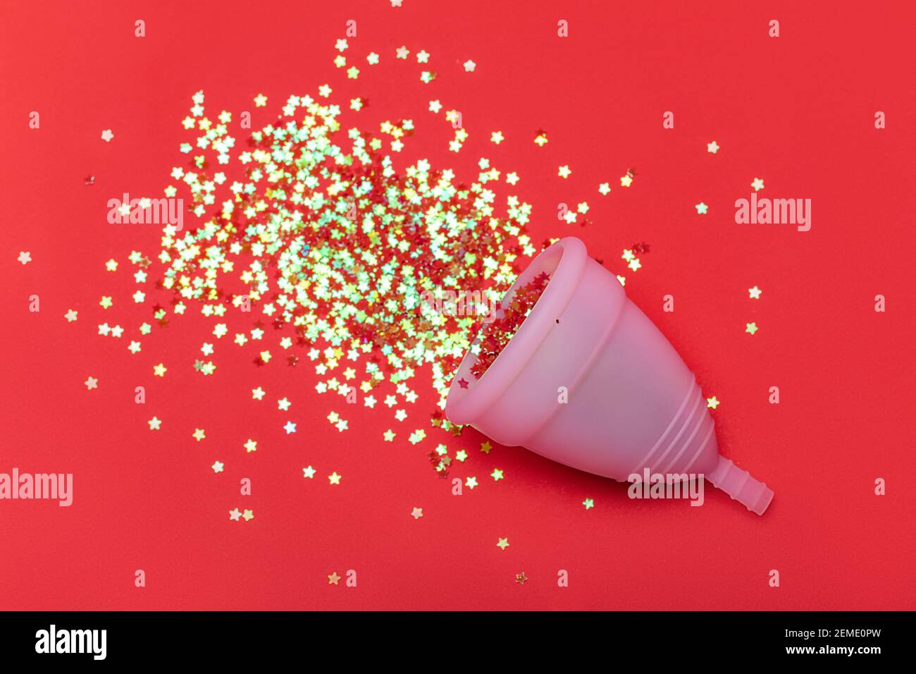 Hygienic menstrual cup cap in spray of puddle of shining stars on ...