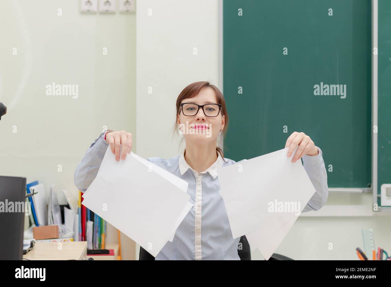 cute young woman teacher at school at her workplace sitting at the ...