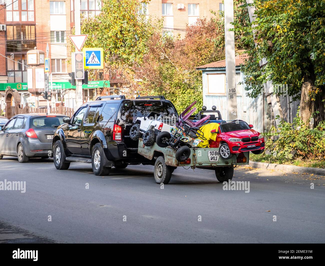TOMSK, RUSSIA - SEPTEMBER 22, 2019: A black SUV car carrying a trailer ...