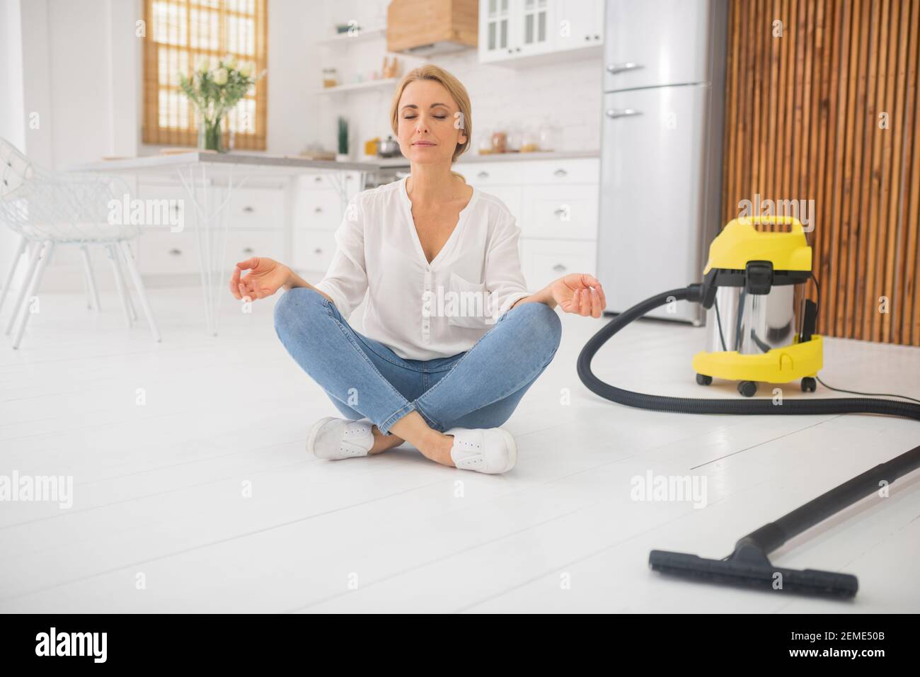 Pretty woman in lotus position after cleaning Stock Photo - Alamy