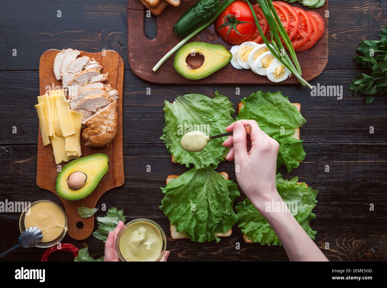 girl chef making sandwich in rustic style with turkey meat and chicken ...