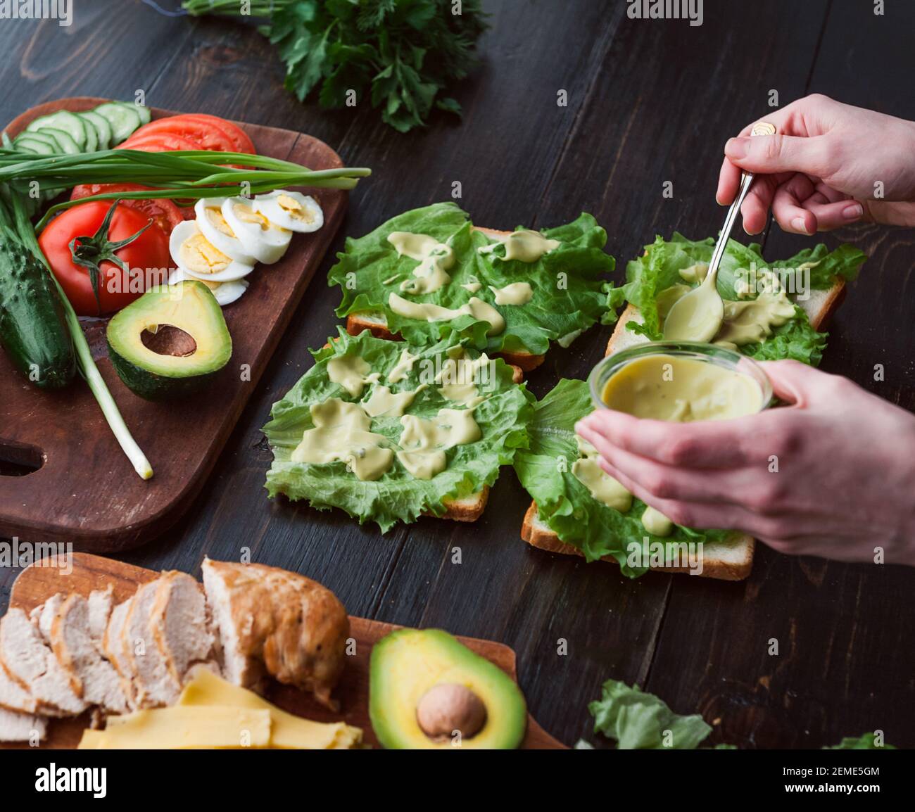 girl chef making sandwich in rustic style with turkey meat and chicken ...