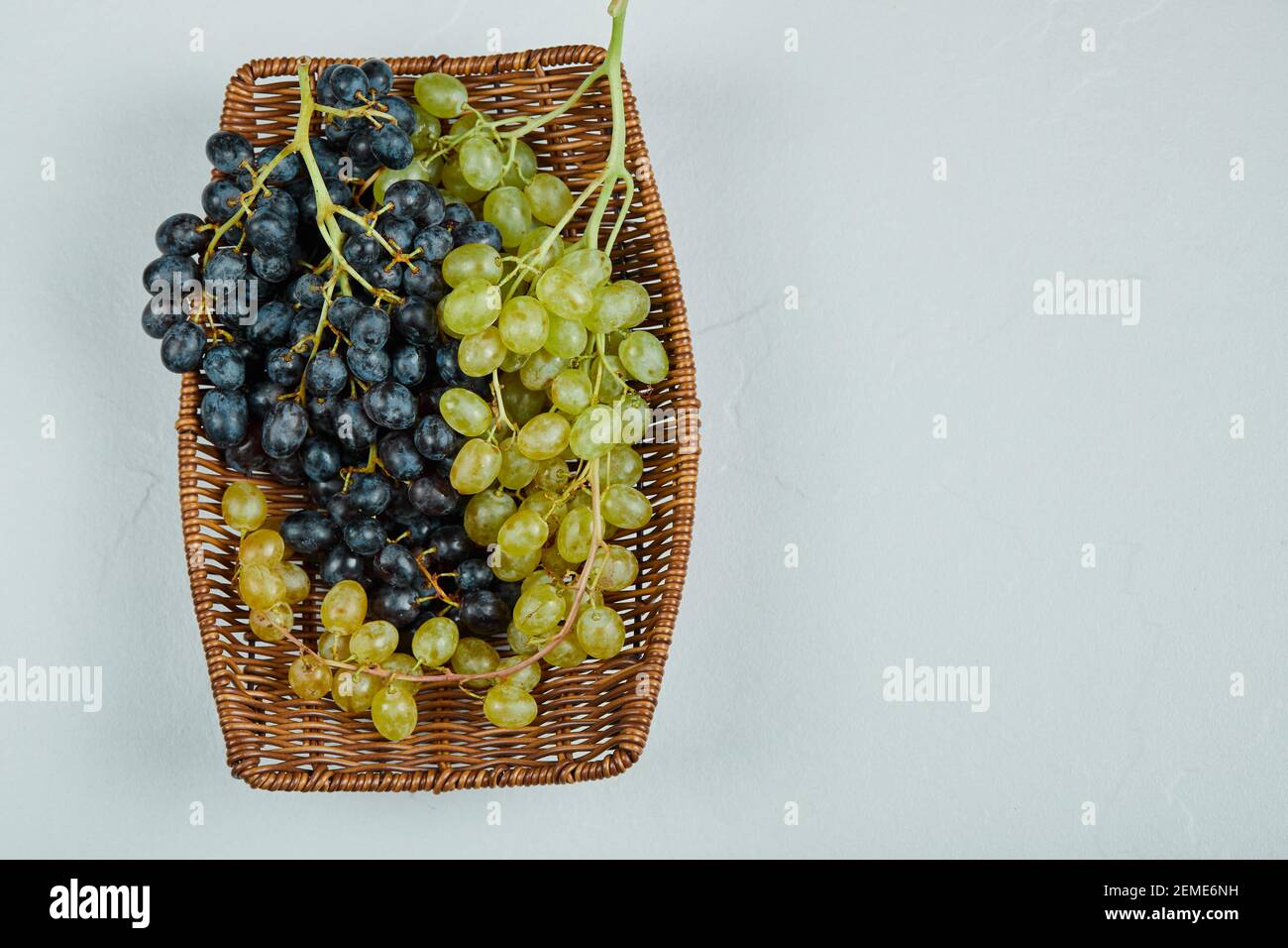 A cluster of mixed grapes in basket on grey background Stock Photo - Alamy