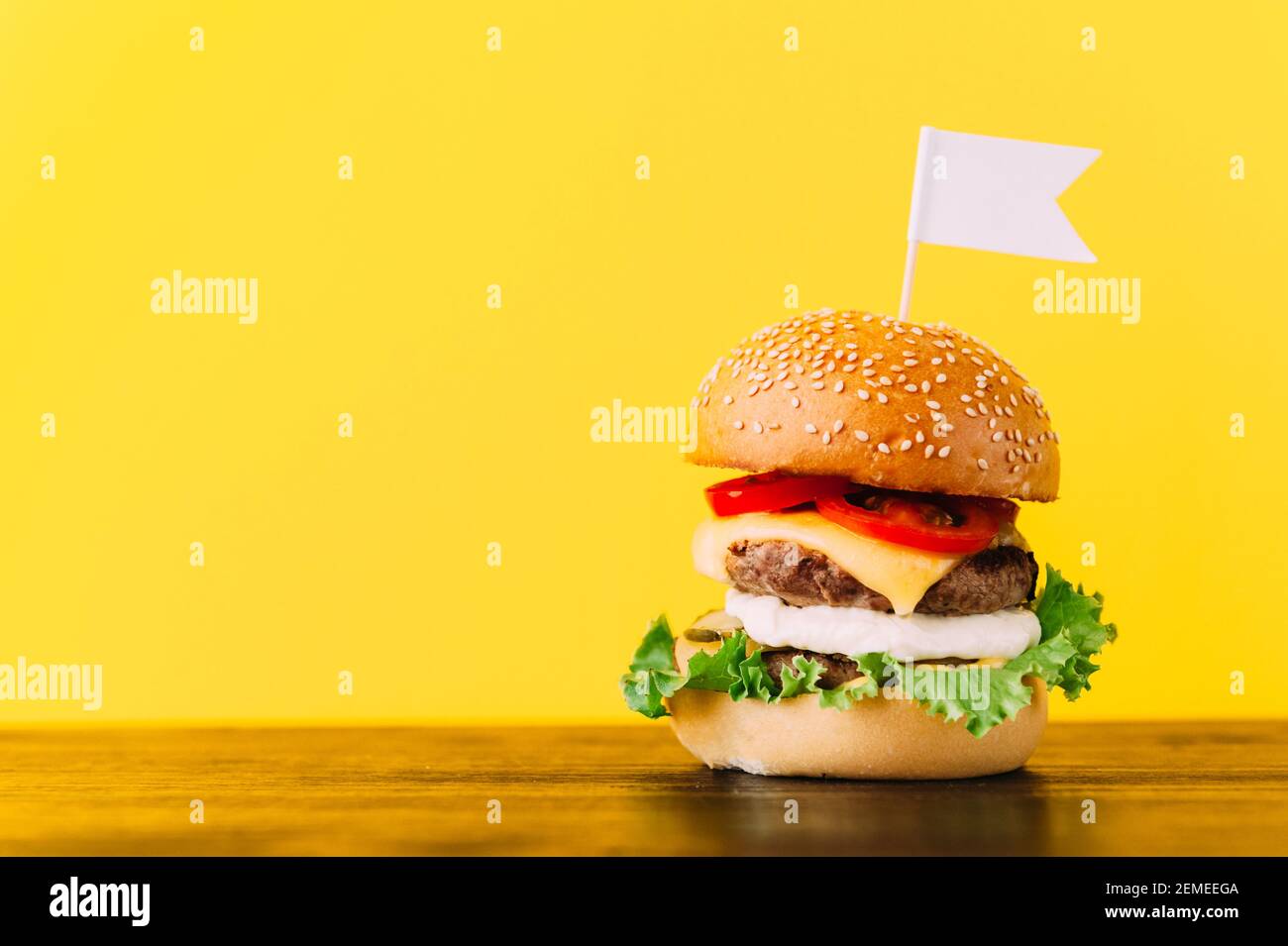 Bright juicy appetizing burgers with chops, cheese, marinated cucumbers ...