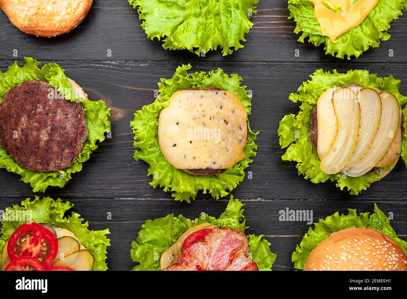 Ingredients for burger. Nine burgers in different stages of readiness ...