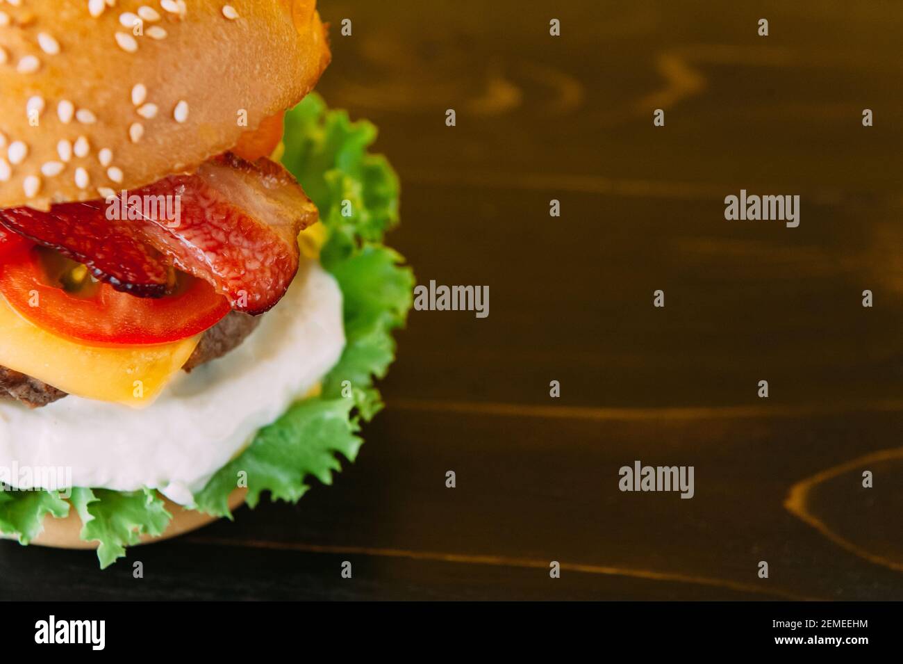 Bright juicy appetizing burgers with chops, cheese, marinated cucumbers ...