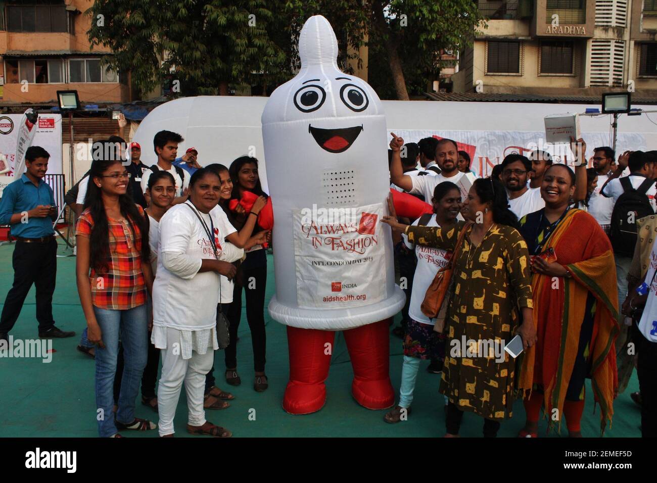 THANE, INDIA - FEBRUARY 13: Youngsters pose with a condom shaped ...