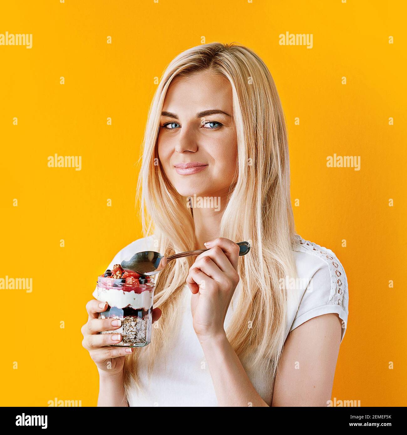 Beautiful young healthy girl on bright sunny background with jars in ...