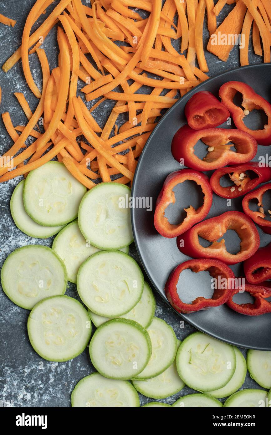 Variety of sliced vegetables on marble background Stock Photo - Alamy