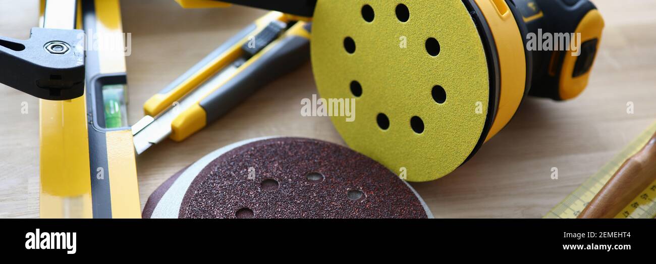 Ruler, grinder and measuring tools for repair and construction lay on ...