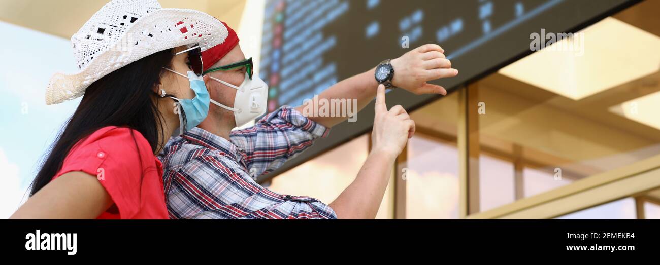 Man and woman check time on their watches Stock Photo - Alamy