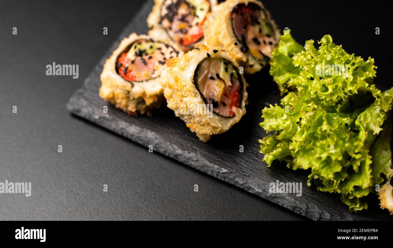 Custom sushi roll in tempura with nori, fresh salmon, tuna, avocado ...