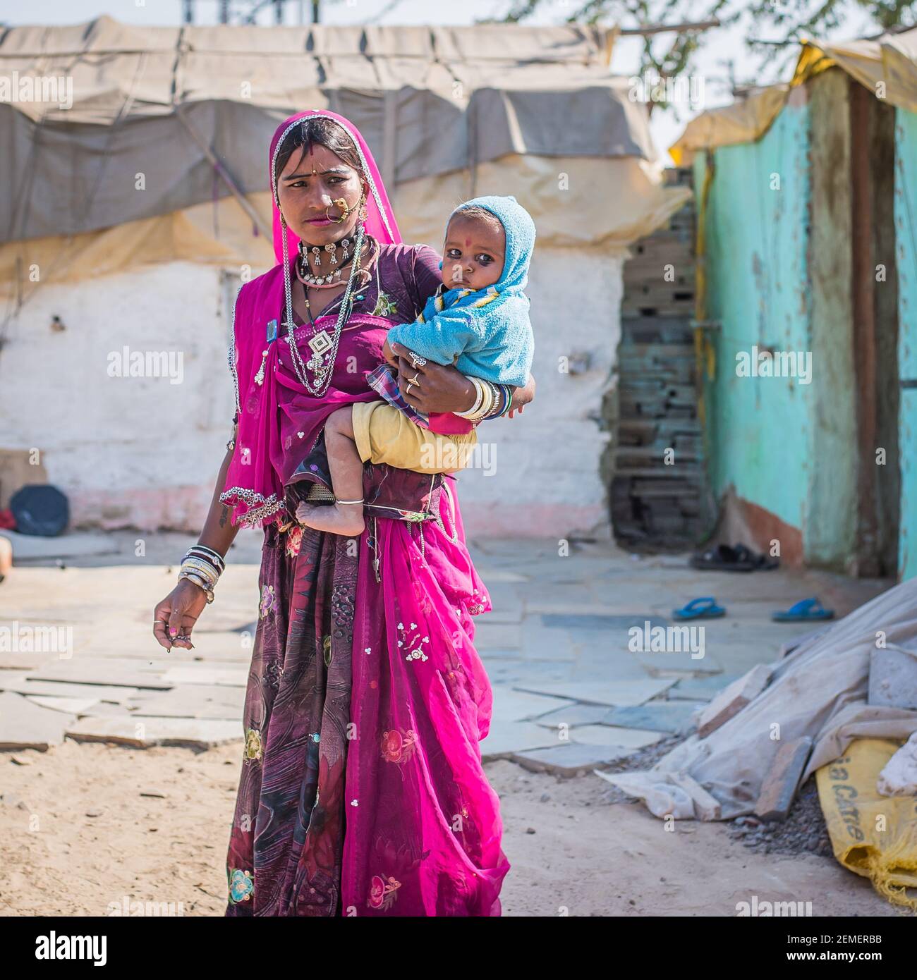 Rajasthan. India. 07-02-2018. Mother holding her child living in very ...