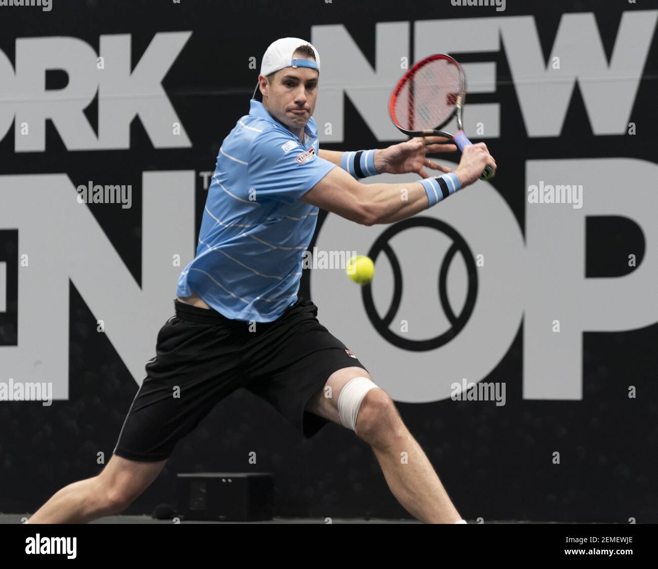 (2/15/2019) John Isner of USA returns ball during quarterfinal match ...