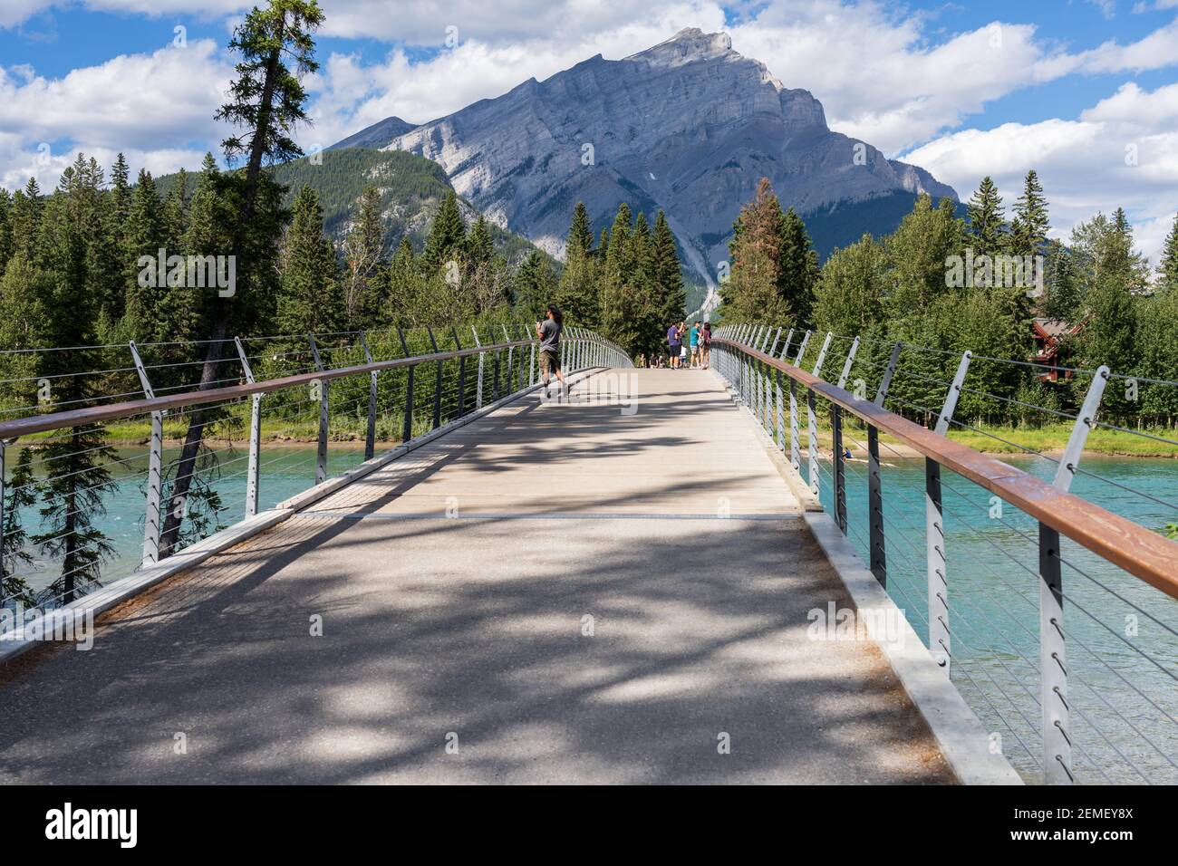 Banff Pedestrian Bridge and Bow River trail in summer sunny day. Banff National Park, Canadian ...