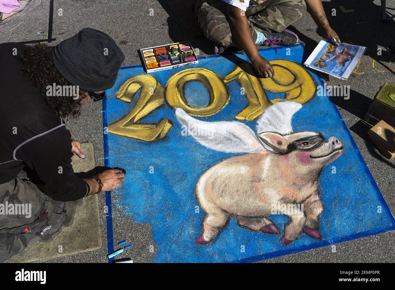 Artists Lori Antoinette and Nelson Pacheco put the finishing touches on ...