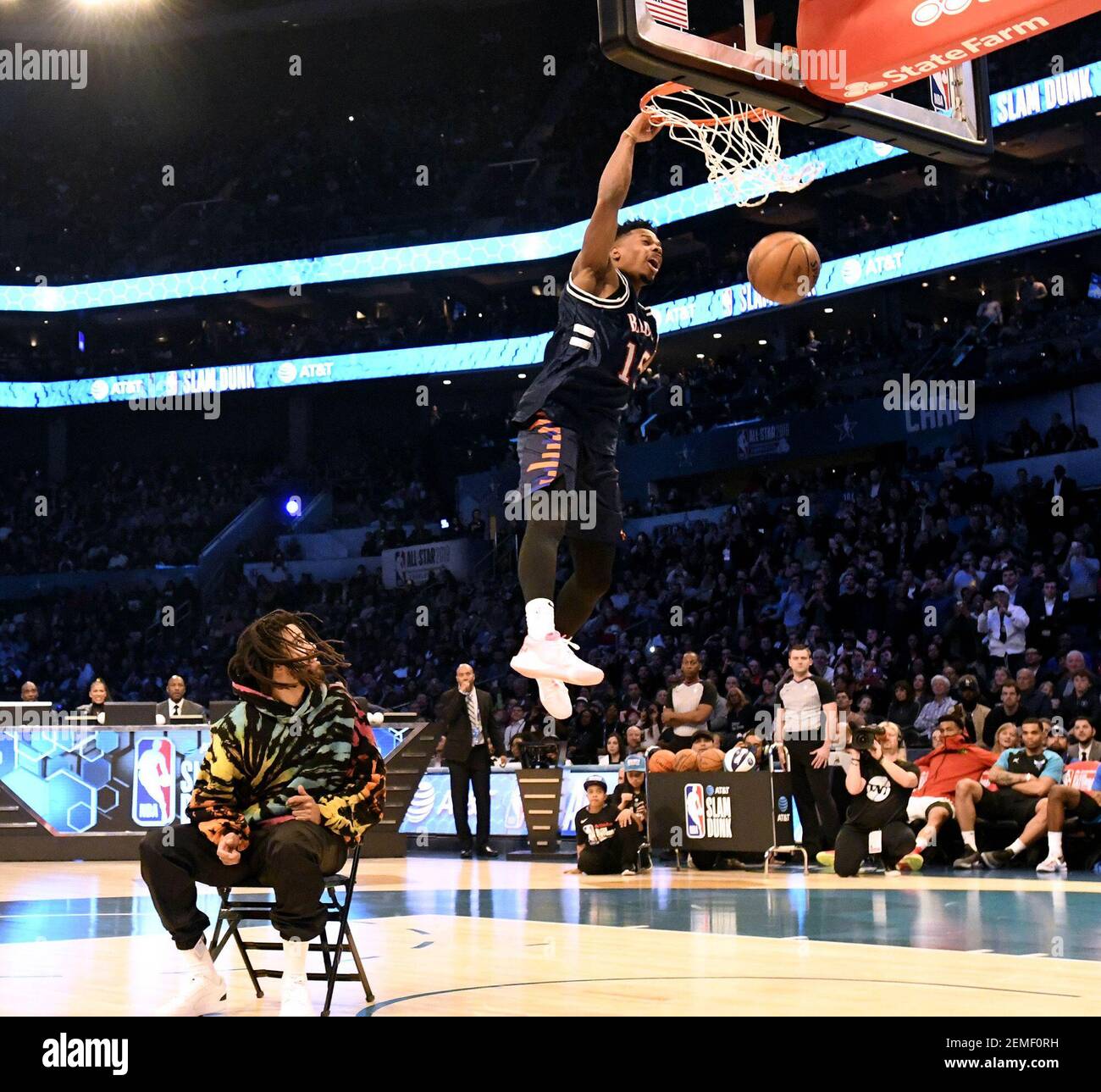 The New York Knicks' Dennis Smith Jr., dunks over entertainer J. Cole ...
