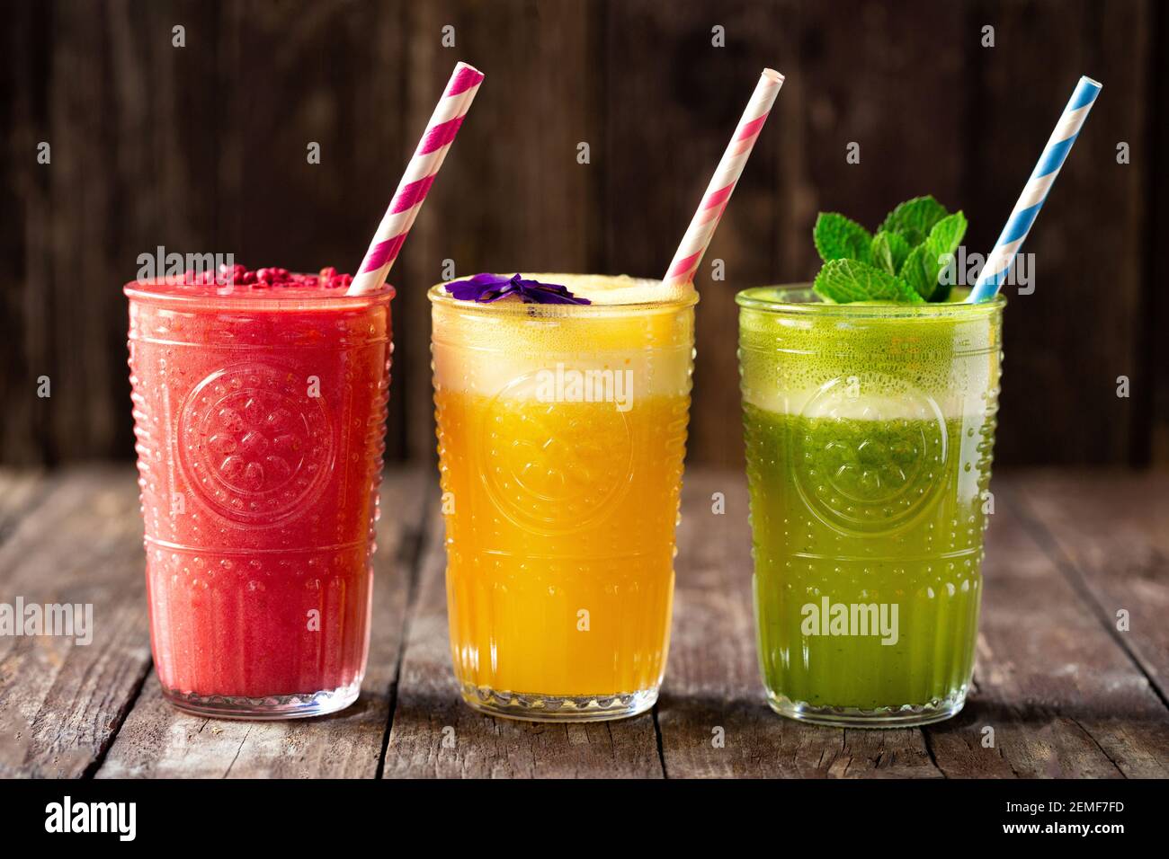 Three smoothies with fine detail decoration on top of them, various ...