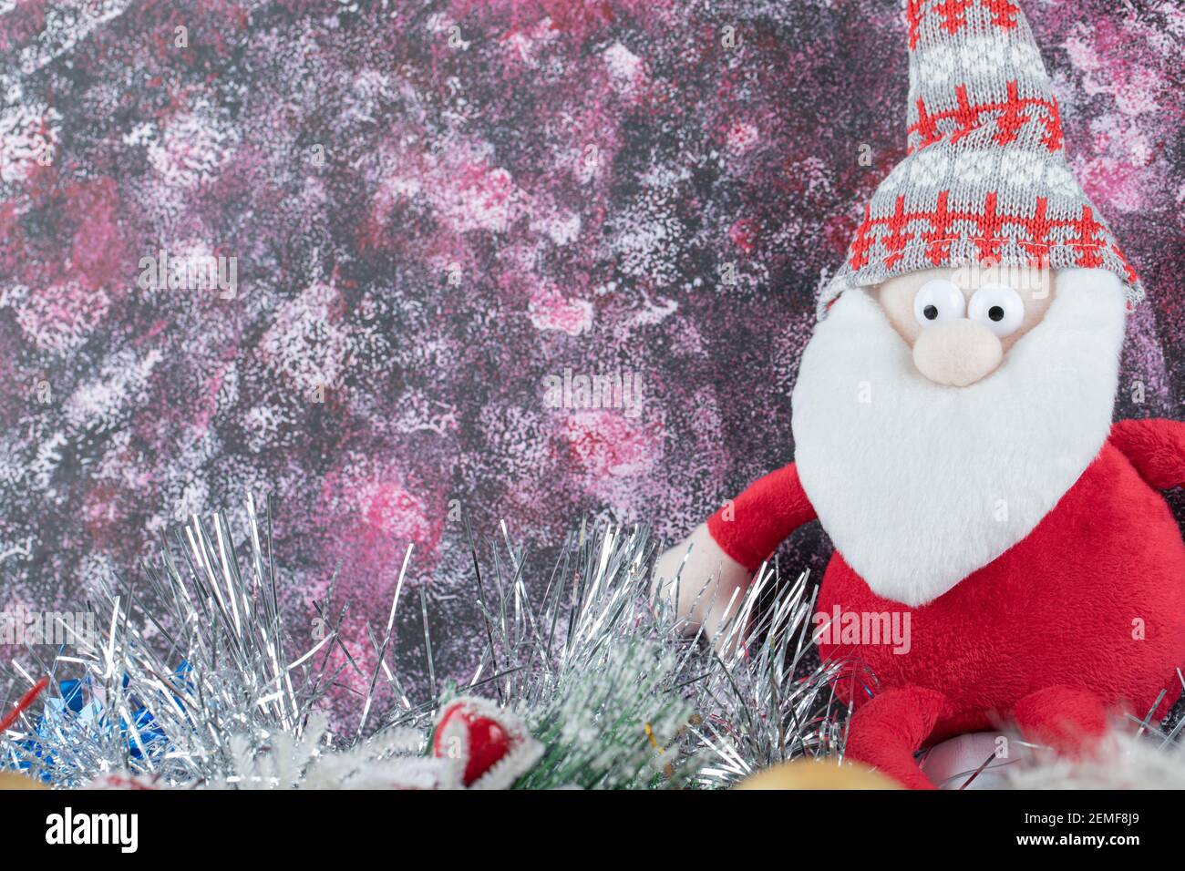 Small Santa figurine on colorful background Stock Photo - Alamy
