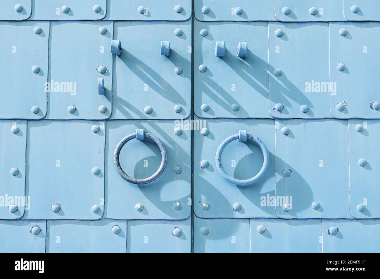 Metal door with rings door handles and metal rivets. Metal door of ...