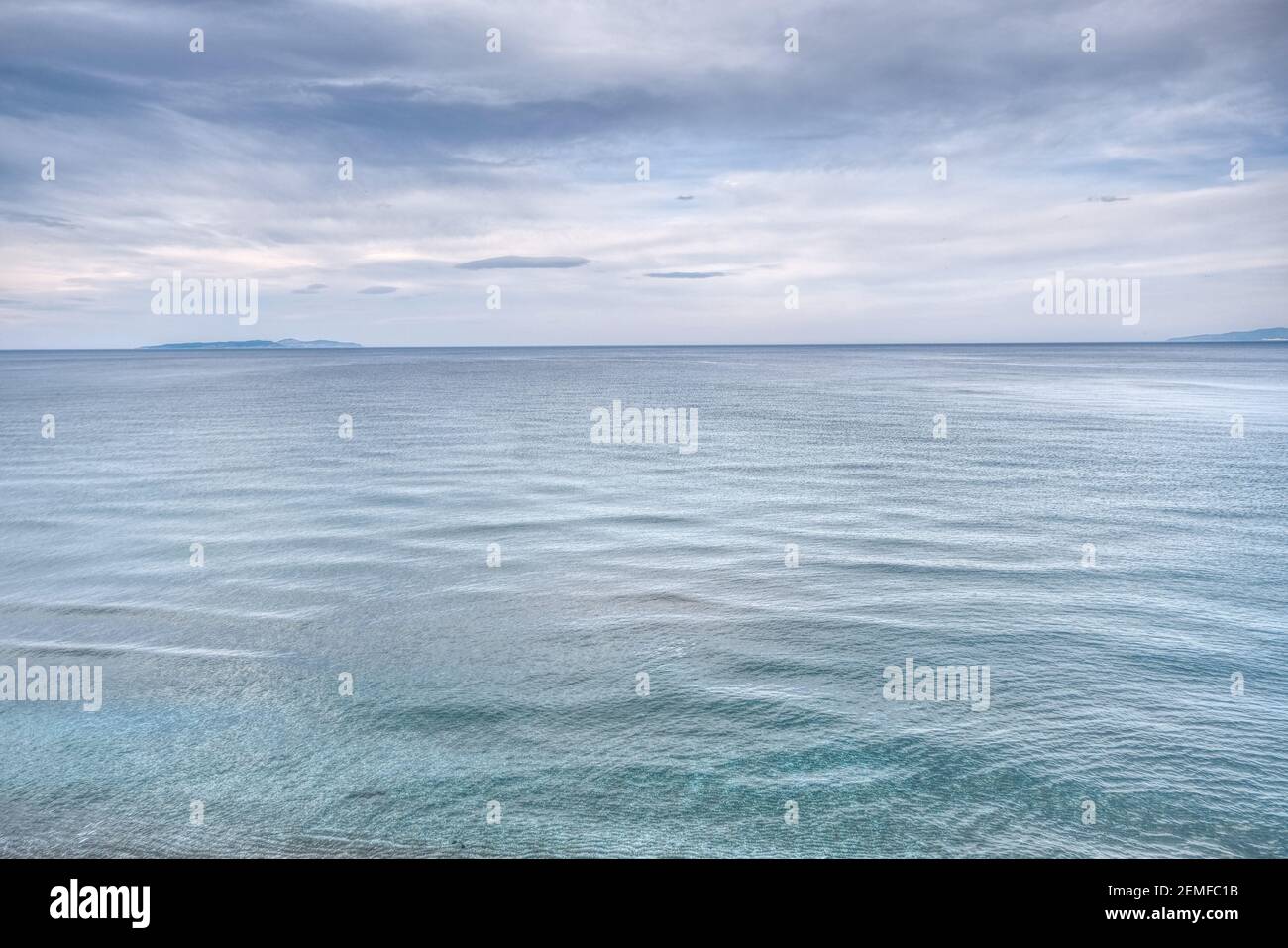 A turquoise color sea and blue sky. high oblique and skyline Stock ...