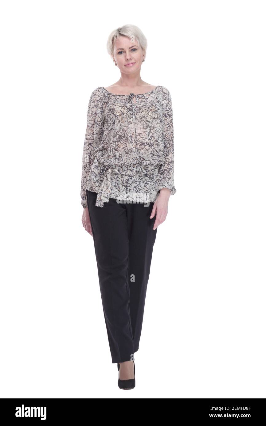 elegant young woman striding forward . isolated on a white background ...