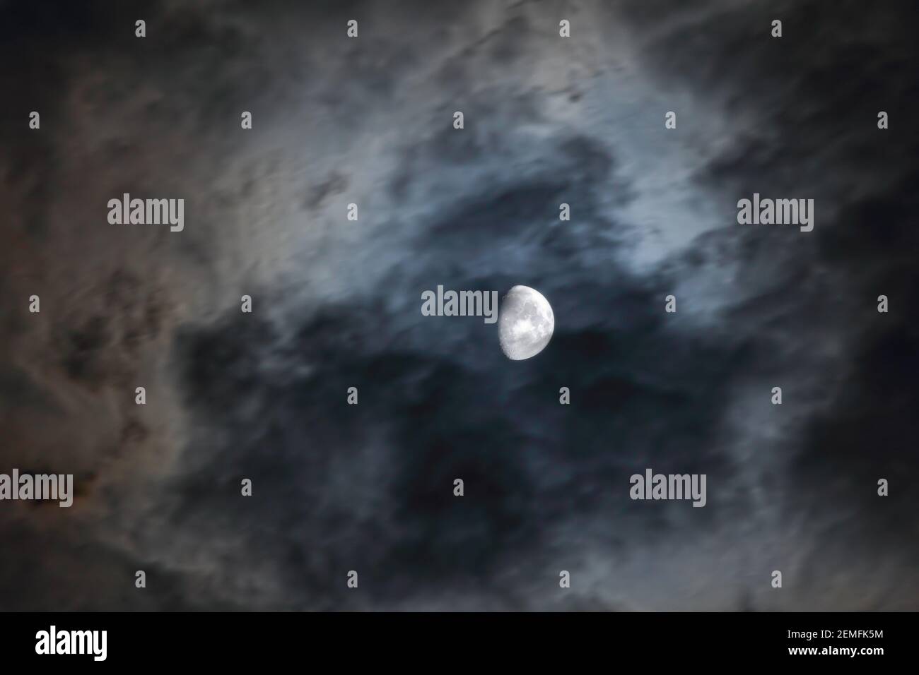 Shining moon with rushing clouds in the stormy, horrorous night sky ...