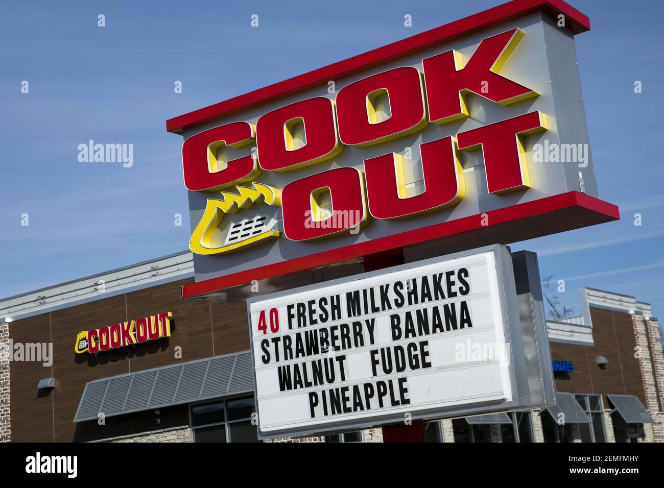A logo sign outside of a Cook Out fast food restaurant location in ...