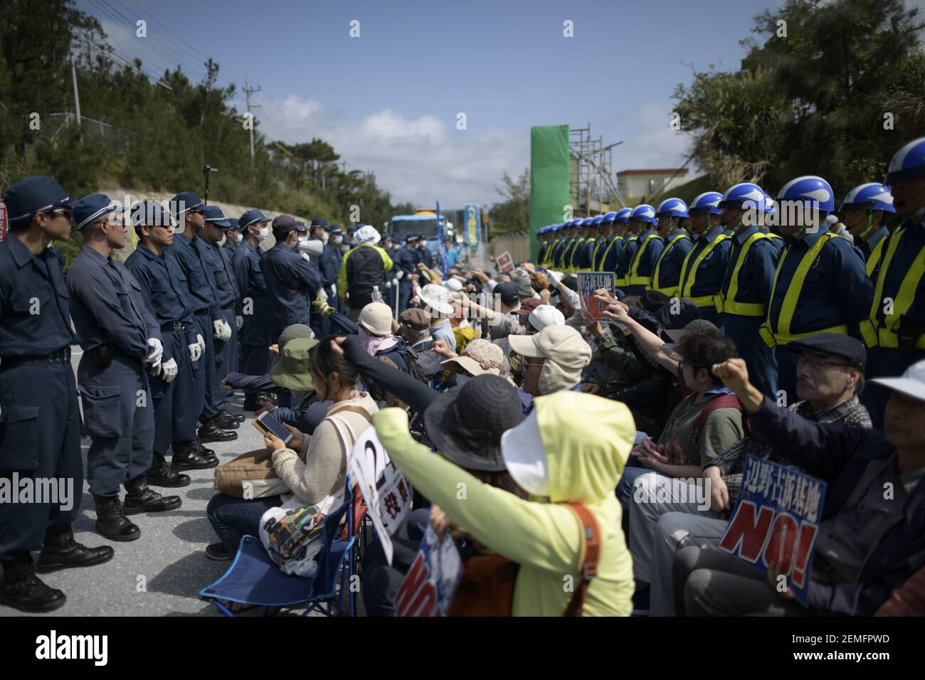 Protesters with placards block construction vehicles from entering the ...