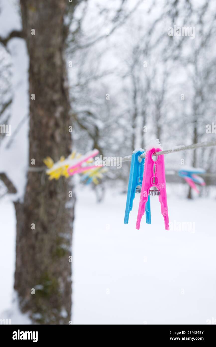 Colorful clothespins hanging on clothesline outside in winter Stock ...