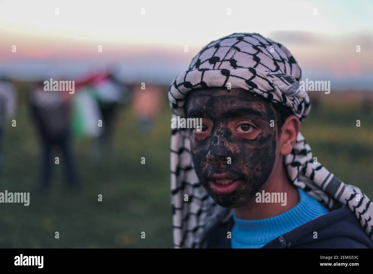 A Palestinian demonstrator seen wearing an official mask in the colours ...