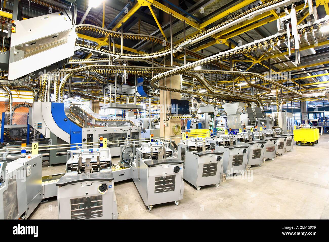 modern machines for transportation in a large print shop for production ...