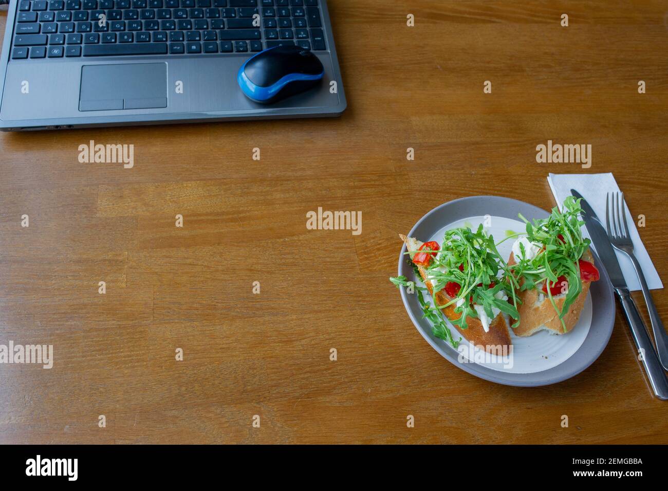 Healthy sandwich on office table. Laptop on the table and a sandwich ...