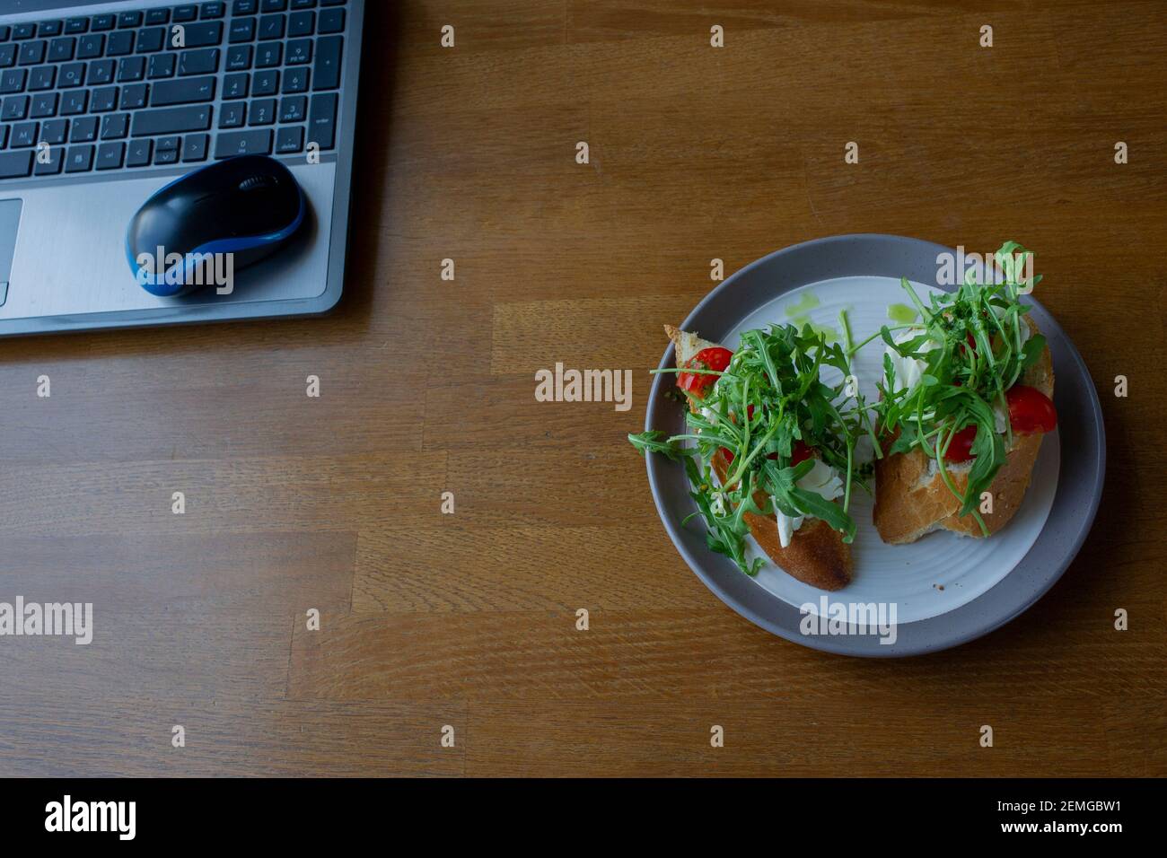 Healthy sandwich on office table. Laptop on the table and a sandwich ...