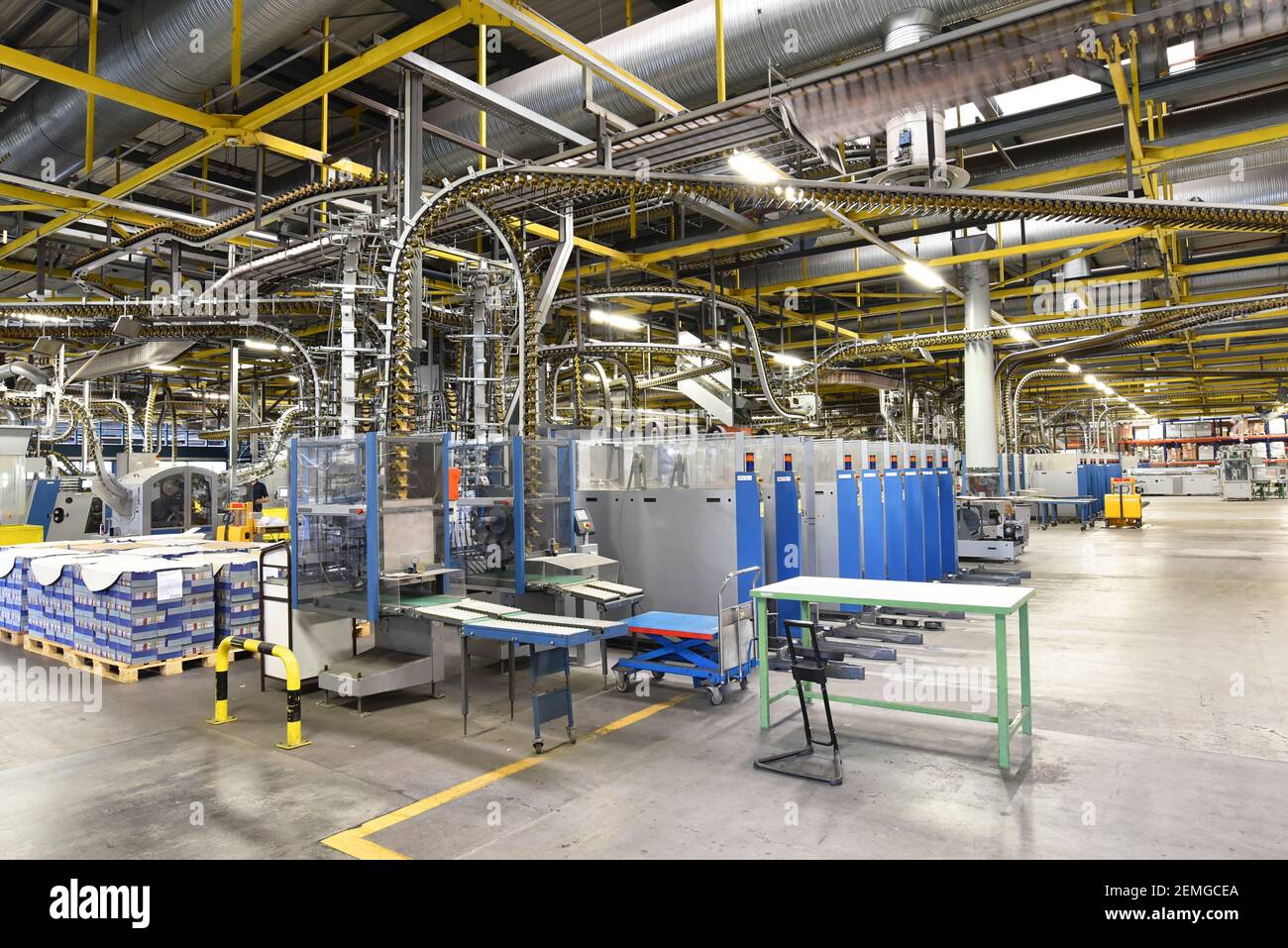 modern machines for transportation in a large print shop for production ...