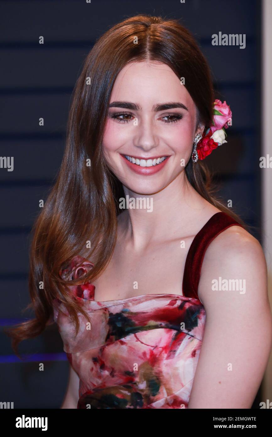 Lily Collins walking on the red carpet at the 2019 Vanity Fair Oscar ...