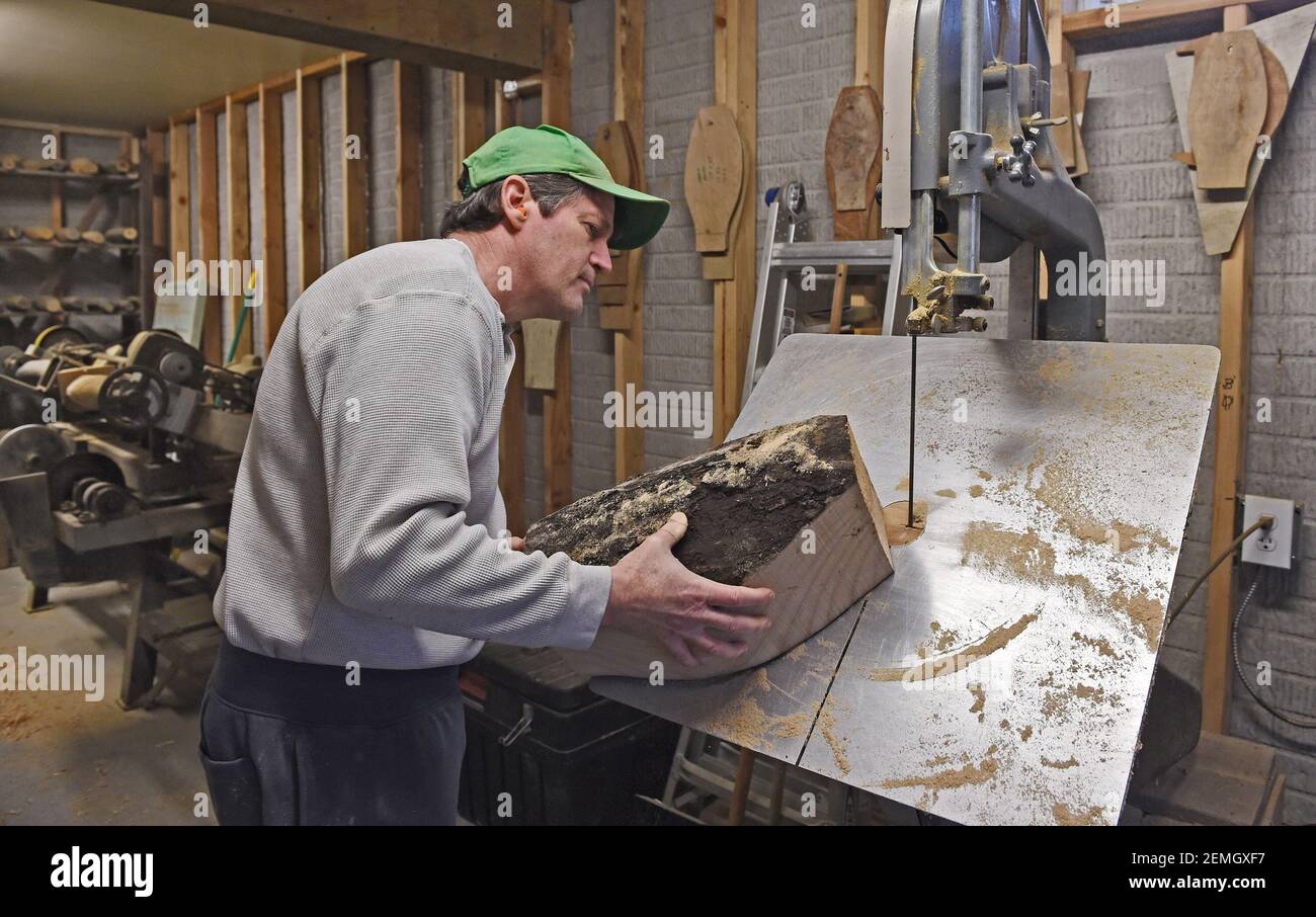 Decoy carver Dan Carson prepares a large chunk of firewood to be turned ...