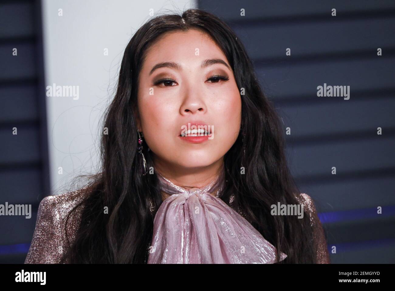 Awkwafina walking on the red carpet at the 2019 Vanity Fair Oscar Party ...