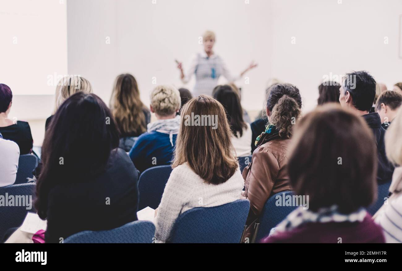 Woman giving presentation on business conference Stock Photo - Alamy