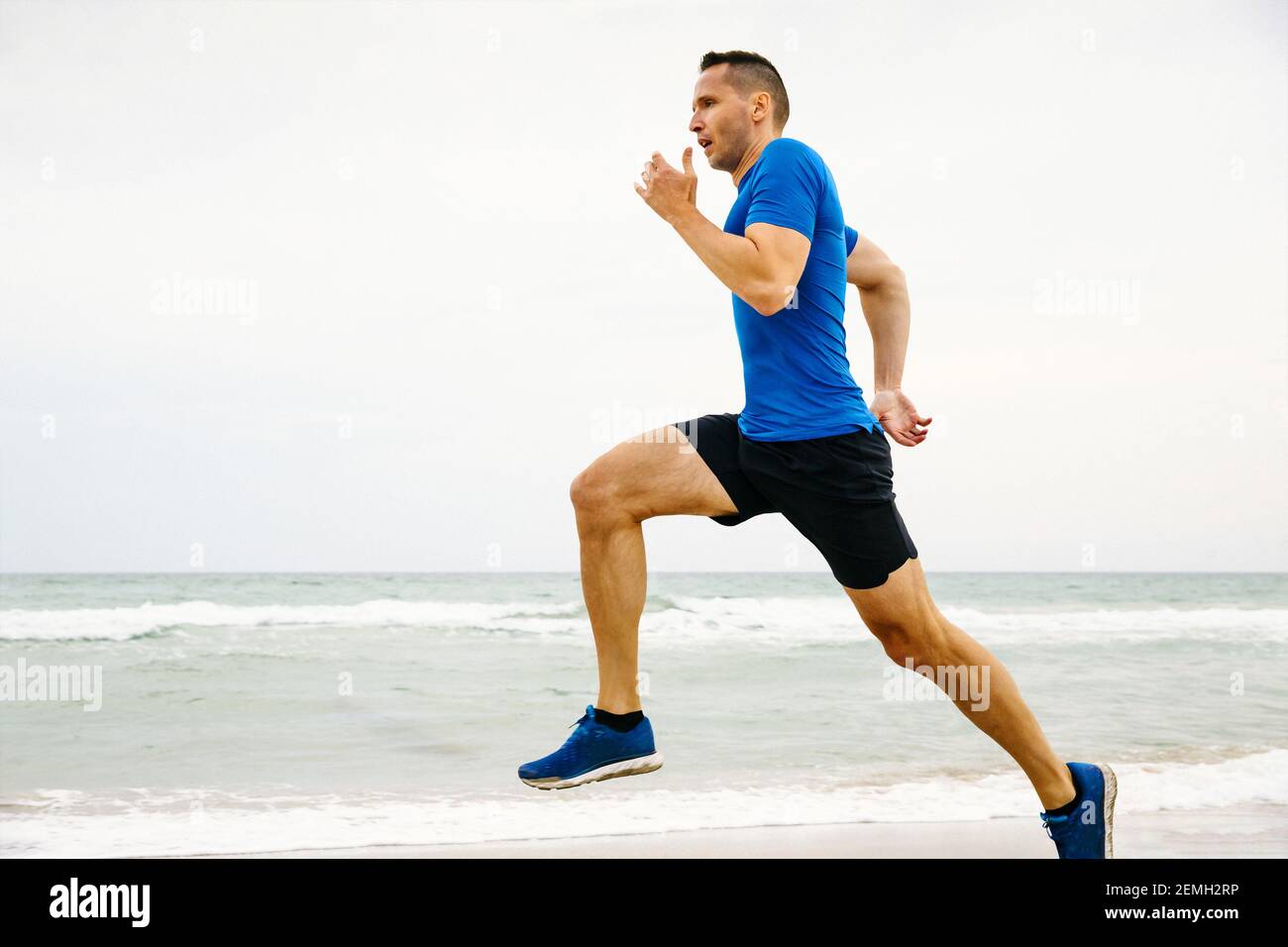 Man running into waves hi-res stock photography and images - Alamy
