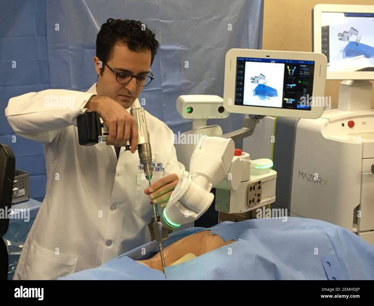 Dr. Eiman Shafa of the Twin Cities Spine Center, left, demonstrated the ...