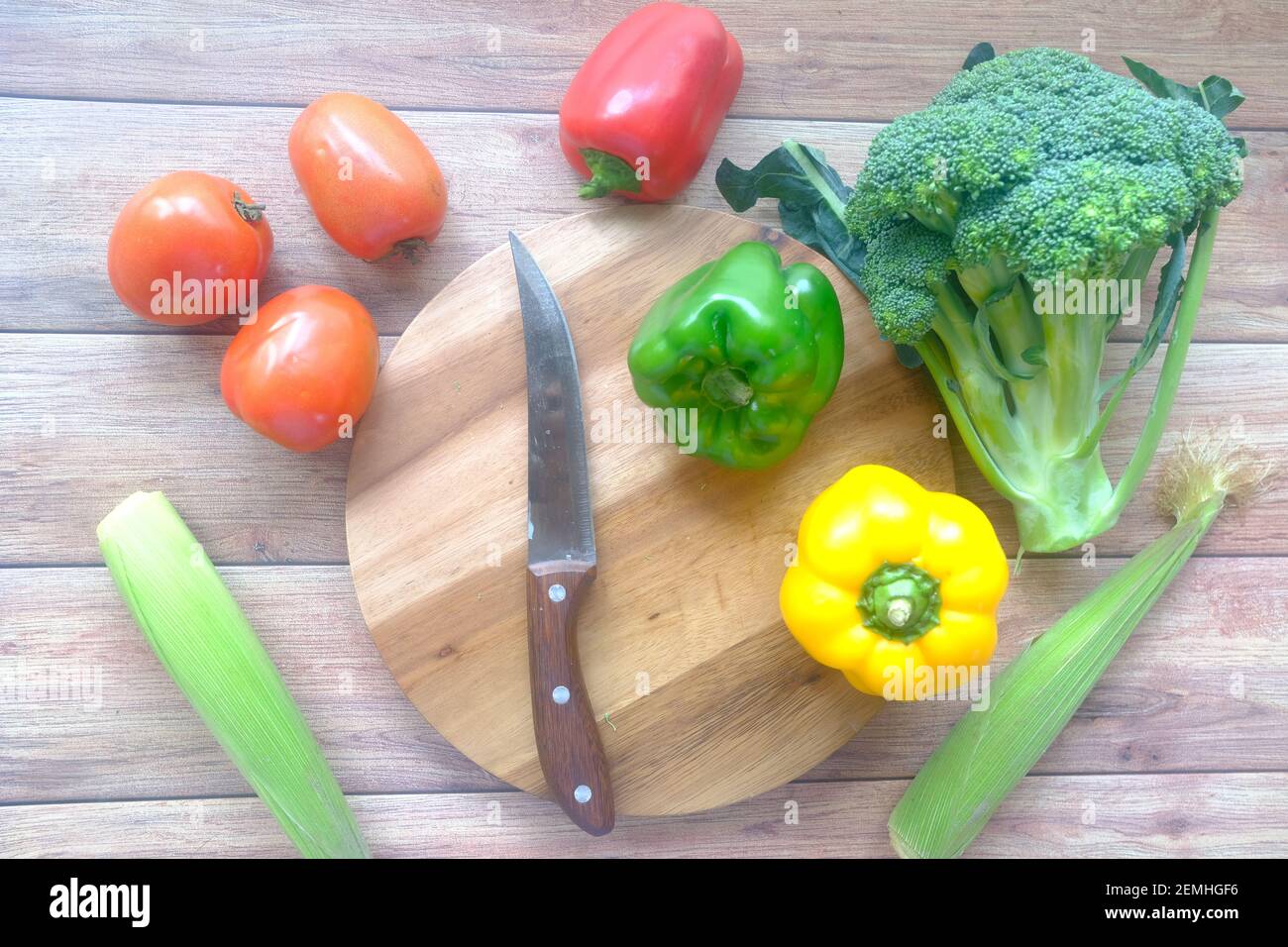 Healthy food selection with fresh vegetables on chopping board on table ...