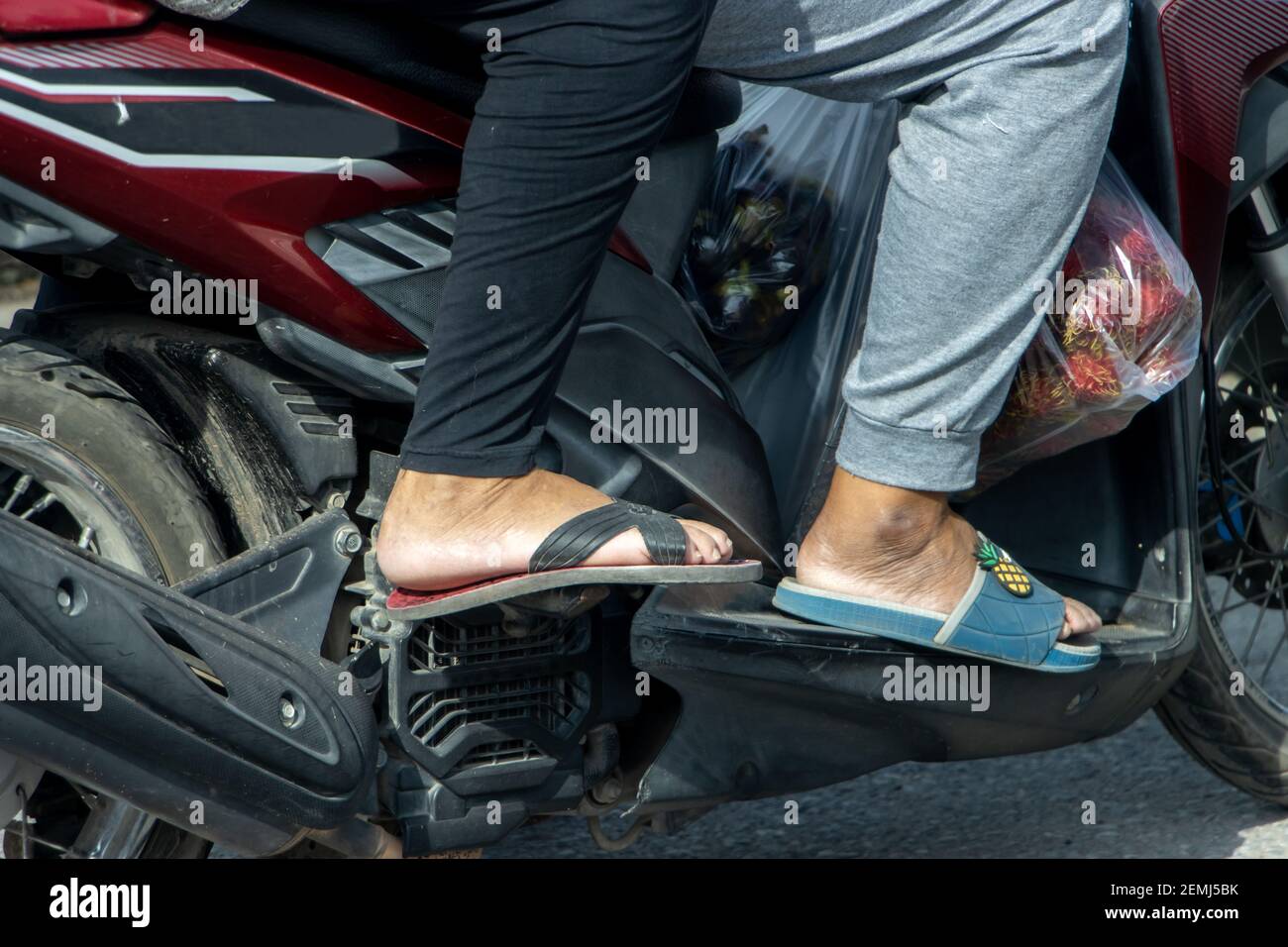 Close-up of people's legs riding a motorcycle Stock Photo - Alamy