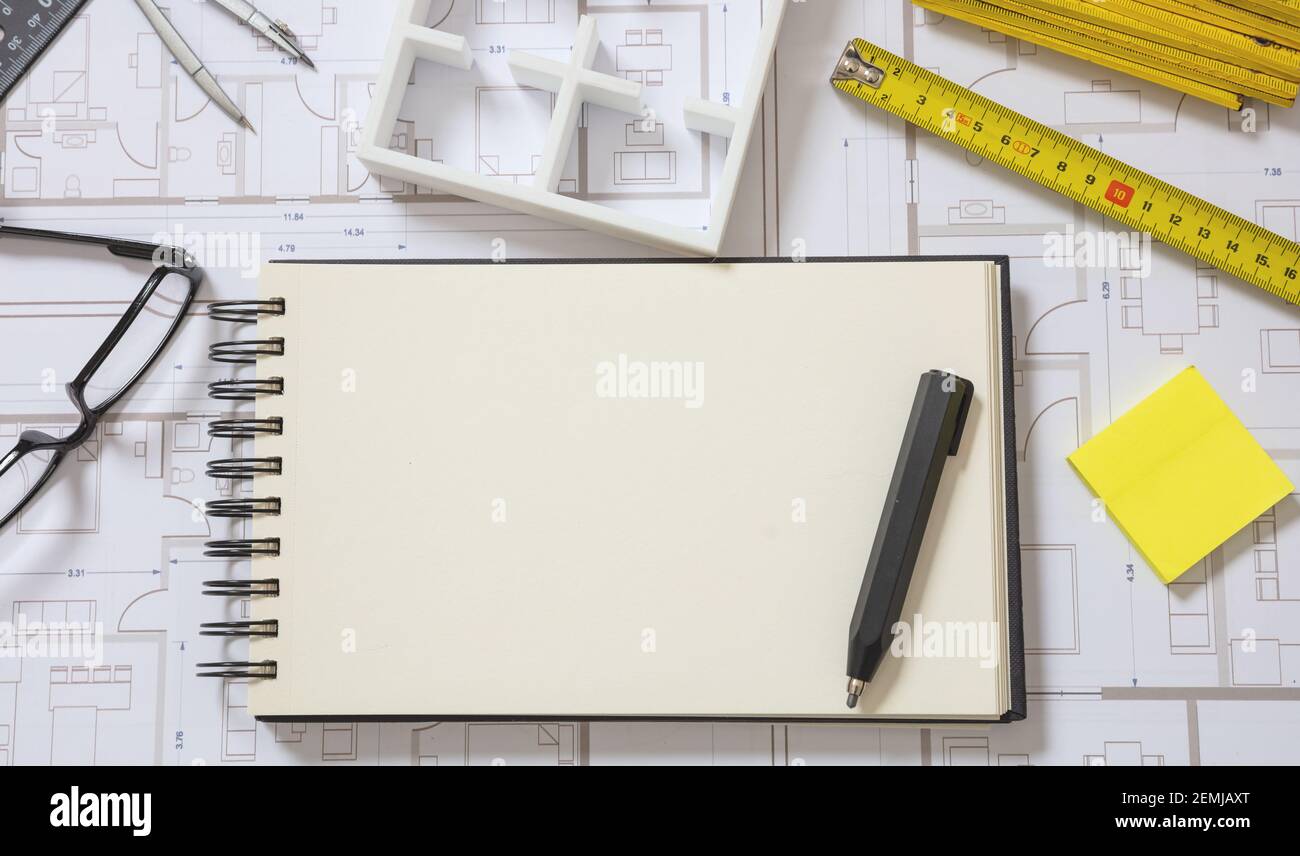Architect engineer pencil on a blank notebook, project blueprints ...
