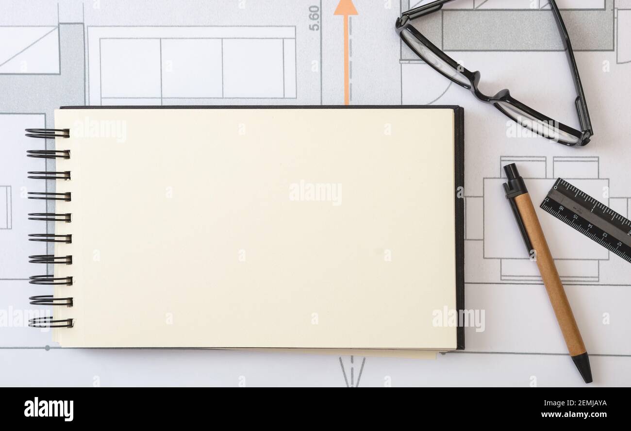 Architect engineer blank notebook, project blueprints background. Real ...
