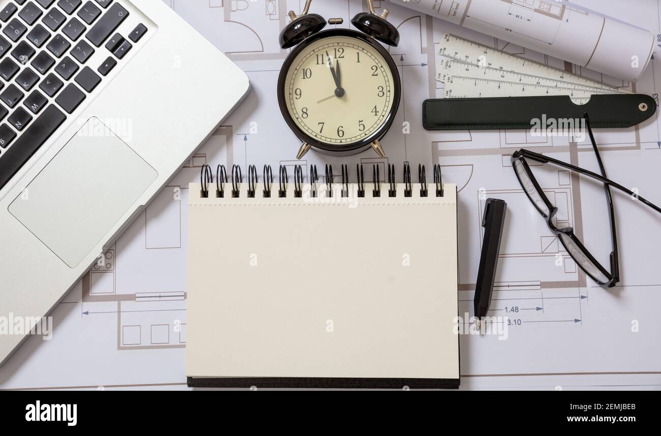 Construction design deadline. Architect engineer blank notebook, laptop ...