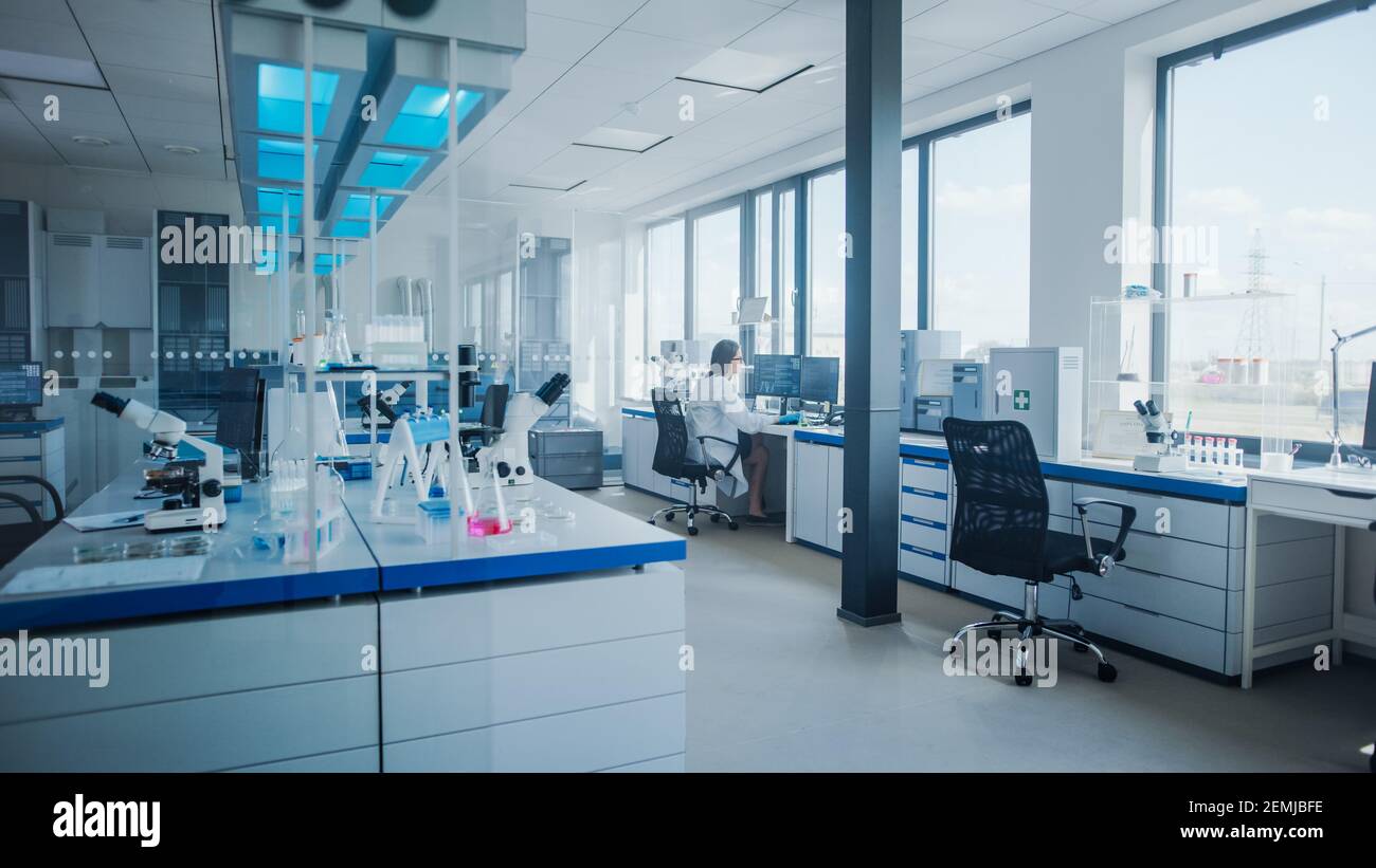 Modern Medical Research Laboratory with Female Scientist Working at the ...