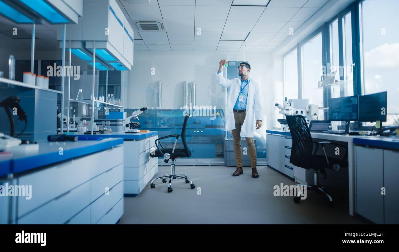 Modern Medical Research Laboratory with Male Scientist Analysing ...